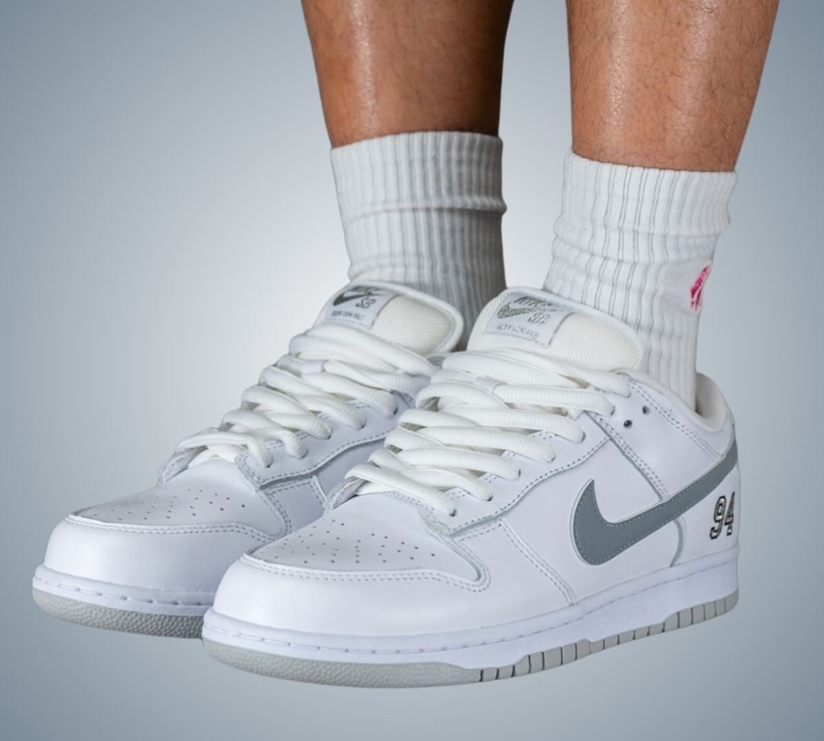 Supreme x Nike SB Dunk Low White Metallic Silver HQ8487-100 | SneakerFiles